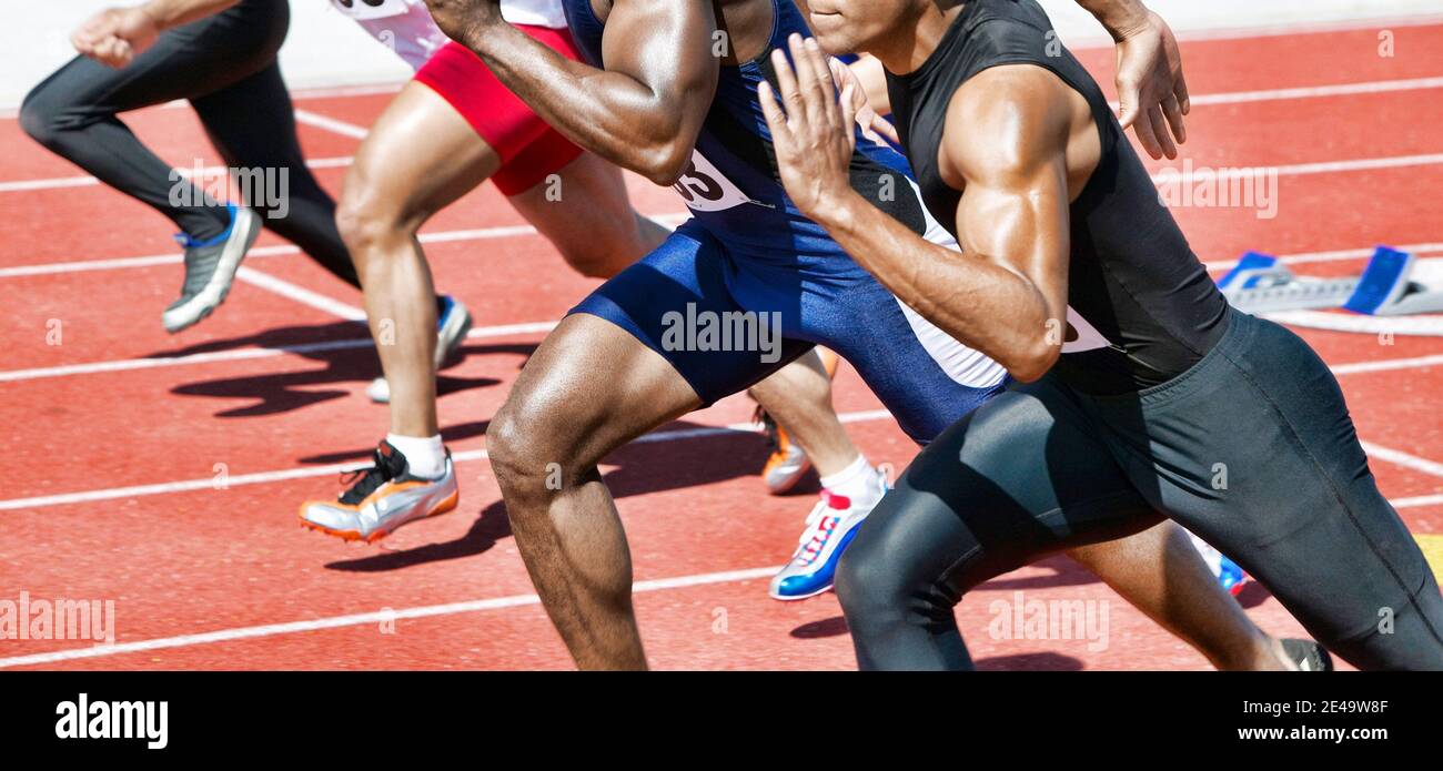 Cropped photo of athlete runners running on track Stock Photo - Alamy