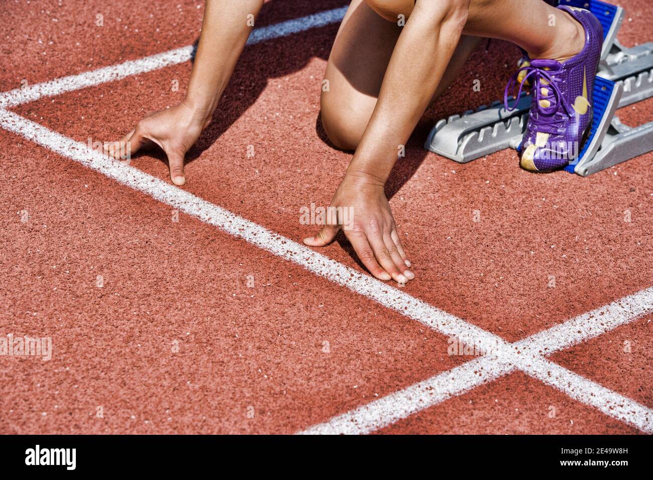 Female athlete in starting block Stock Photo - Alamy