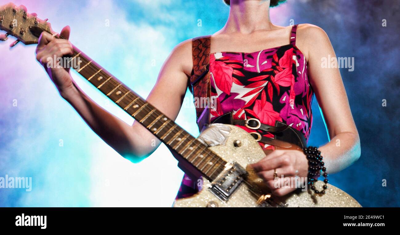 Female rock guitarist on stage in concert Stock Photo - Alamy