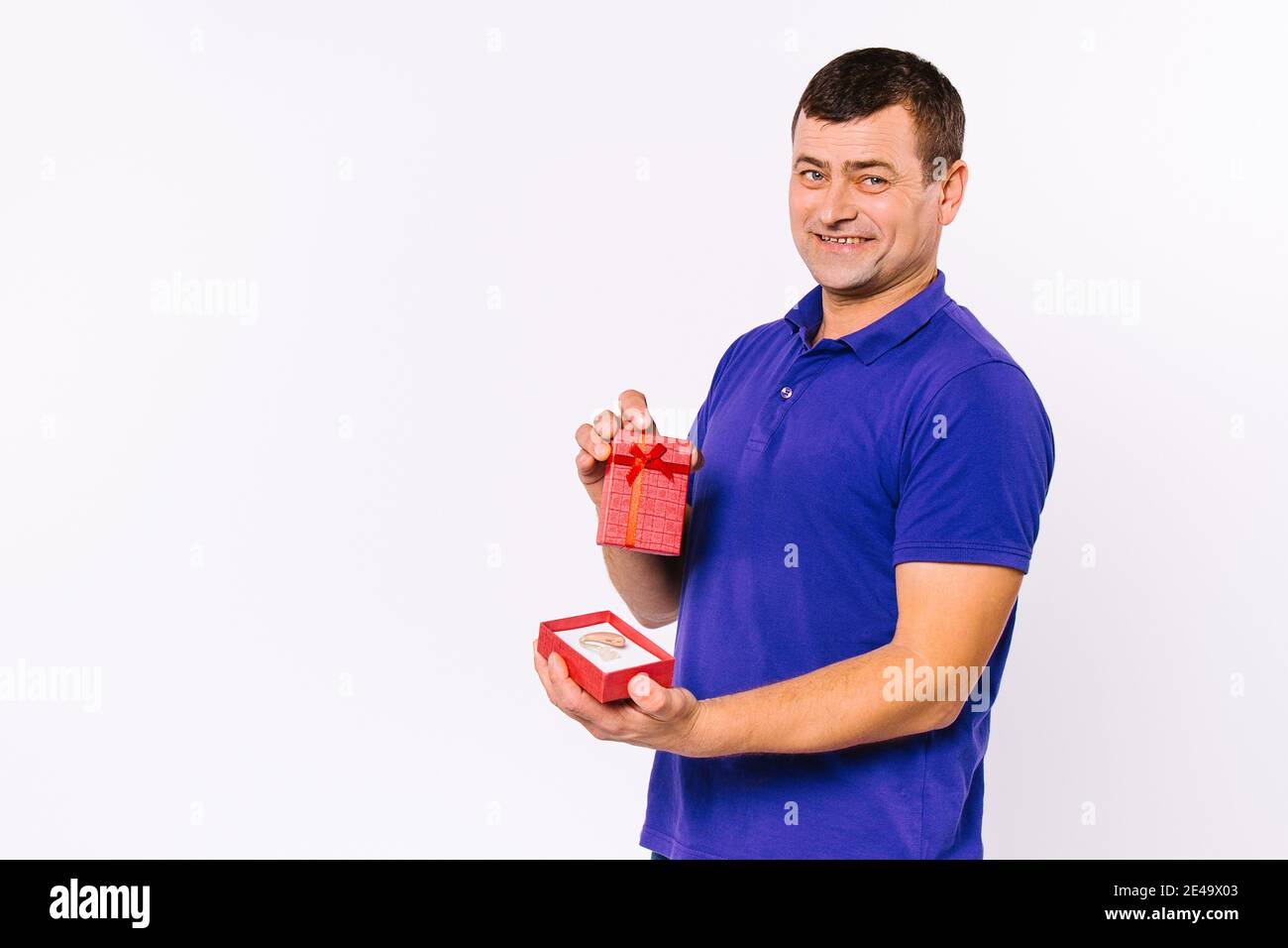 A satisfied deaf man received a hearing aid in a red gift box as a ...