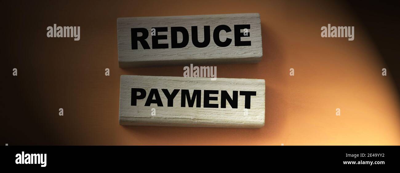 Wooden blocks with the words Reduce payment. Business concept Stock ...