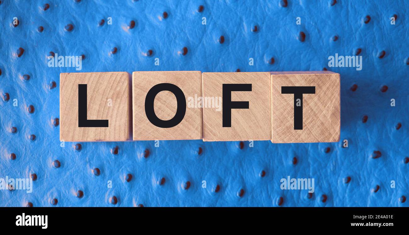 word loft letters on wooden cubes, on red leather background. Interior ...