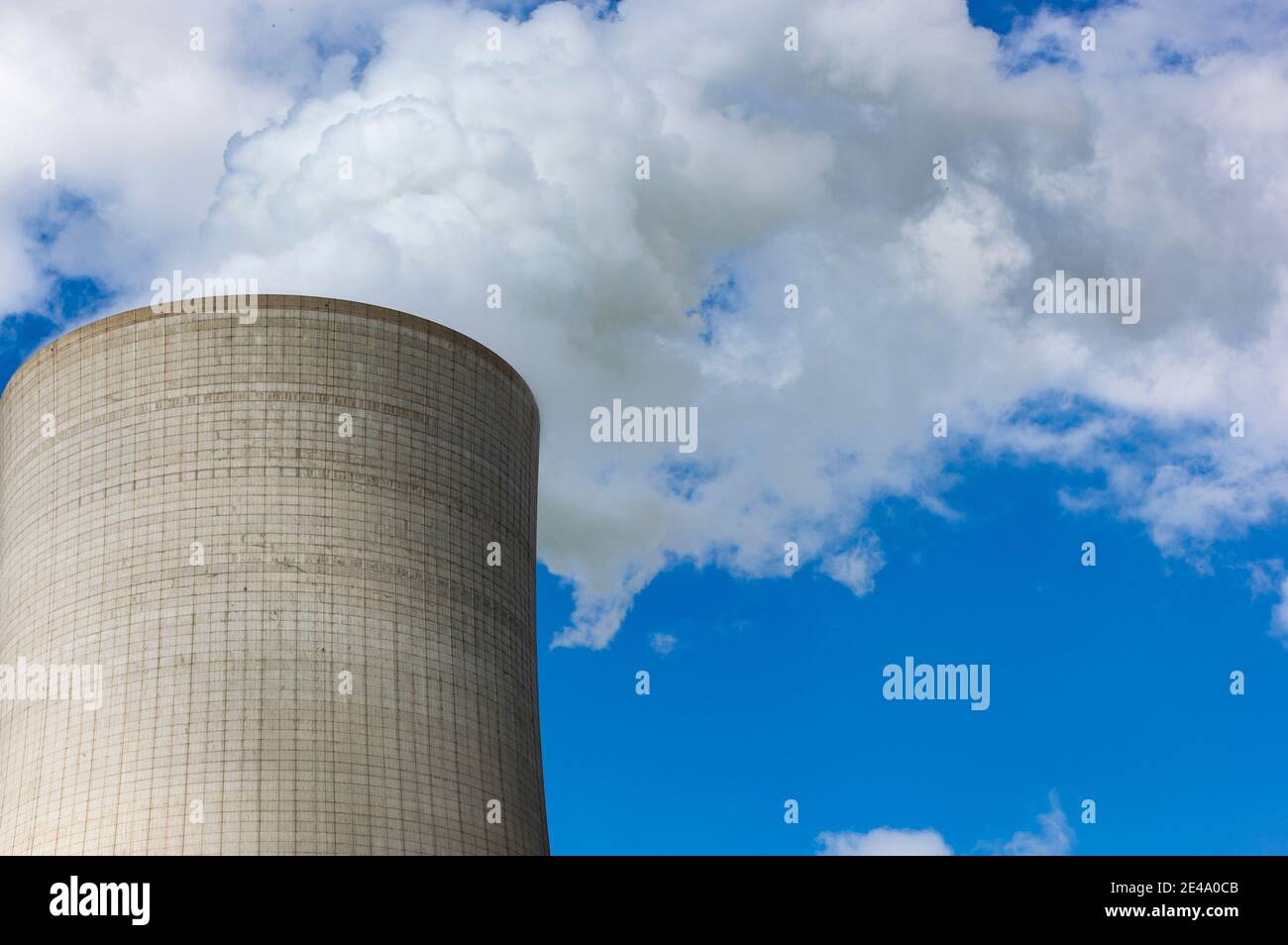 The image shows a smoking industrial tower with blue sky Stock Photo ...
