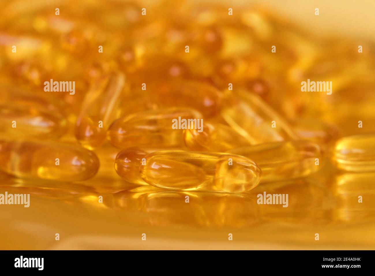 fish oil capsules close-up on blurred gold background.Fish oil in ...