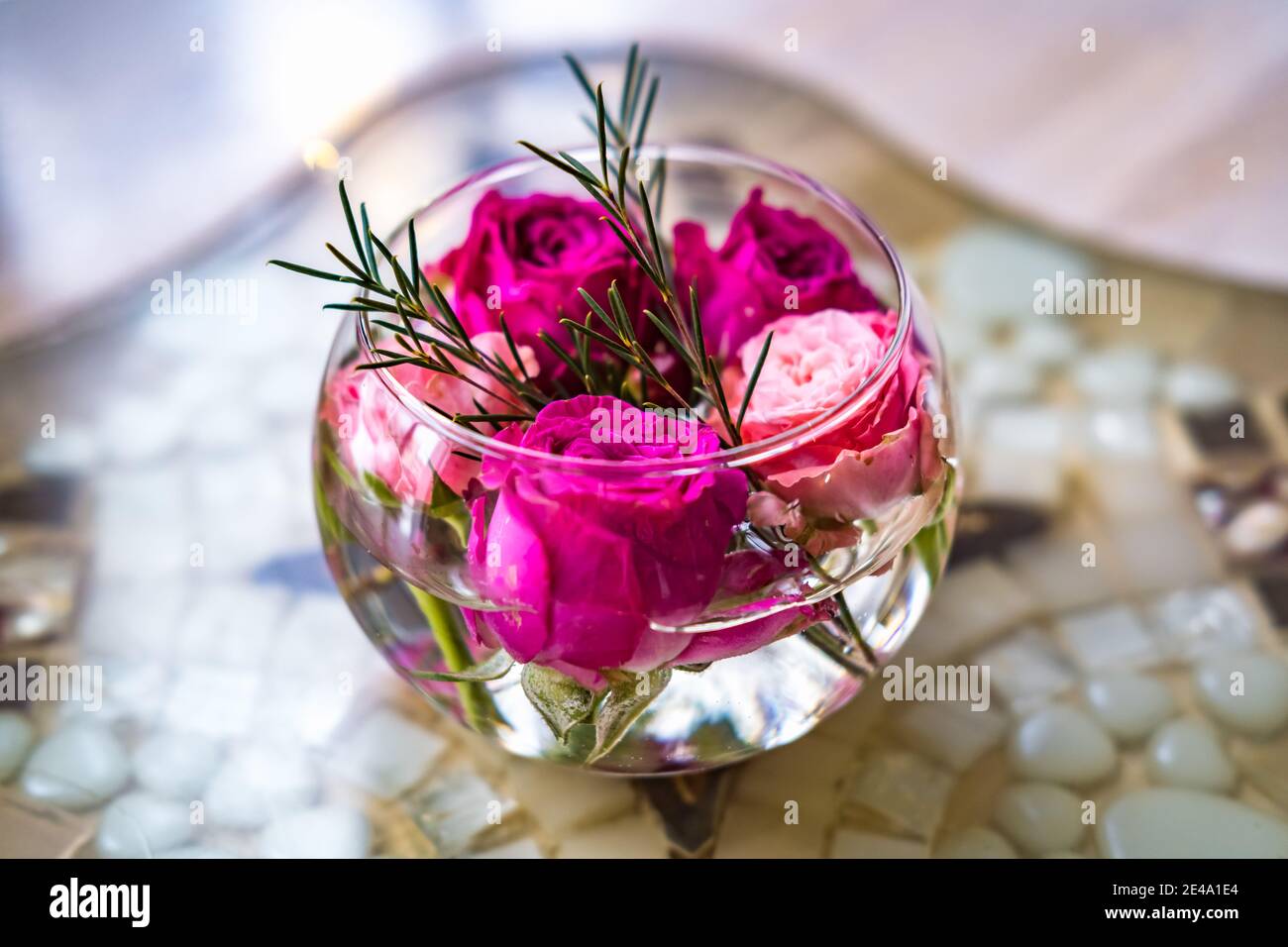 decoration pink rose buds in a glass of water Stock Photo - Alamy