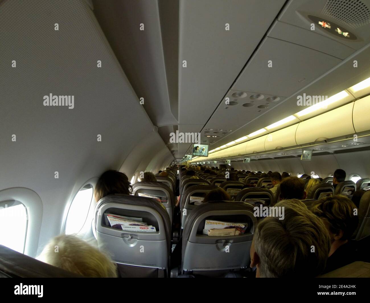 fully loaded airplane with seated passengers Stock Photo - Alamy