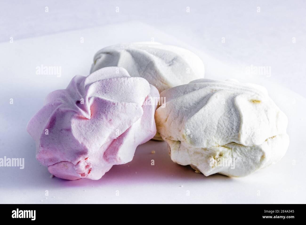 Three marshmallows, pink and white, on grey background Stock Photo - Alamy