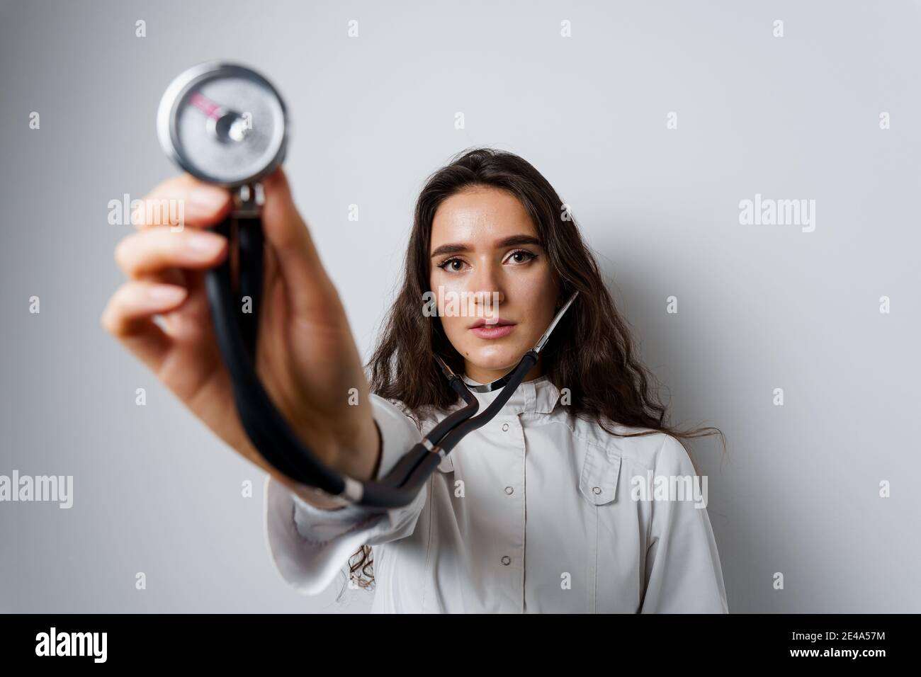 Smiley woman doctor surgeon with stethoscope on white background ...