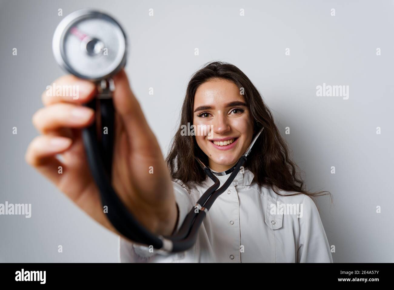 Smiley woman doctor surgeon with stethoscope on white background ...