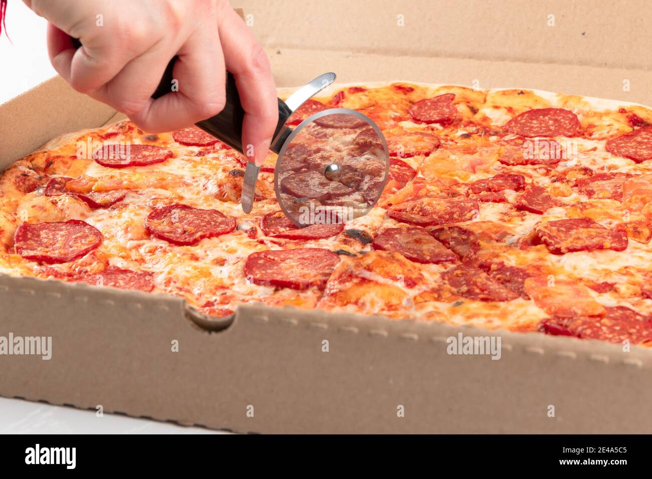 female hand cuts fresh aromatic hot Italian mozzarella pizza. close-up ...