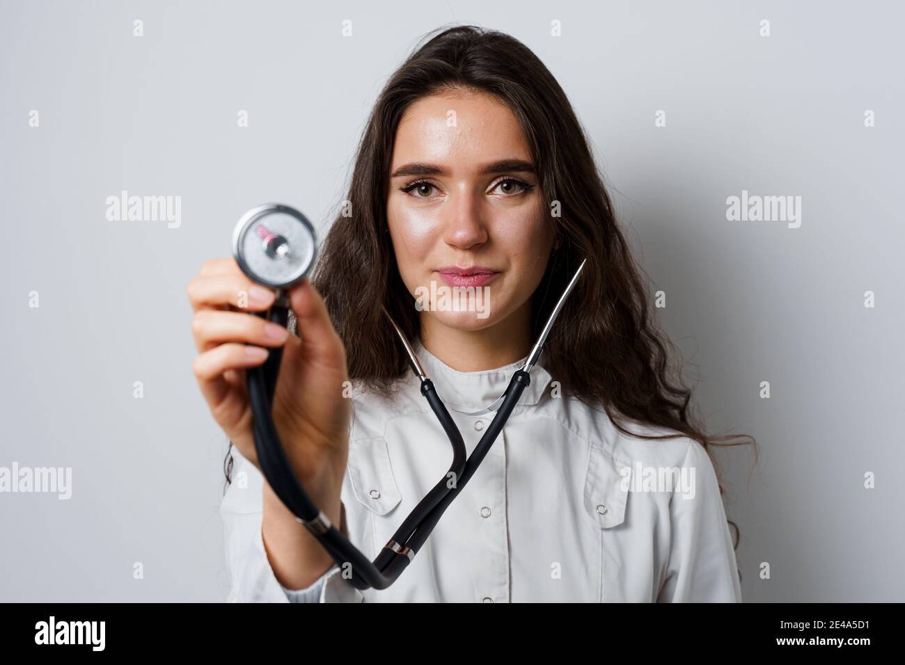 Smiley woman doctor surgeon with stethoscope on white background ...