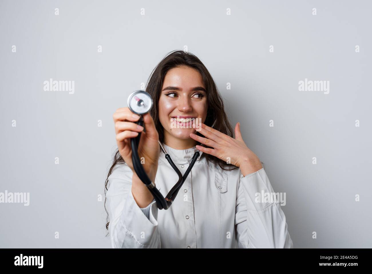 Smiley woman doctor surgeon with stethoscope on white background ...