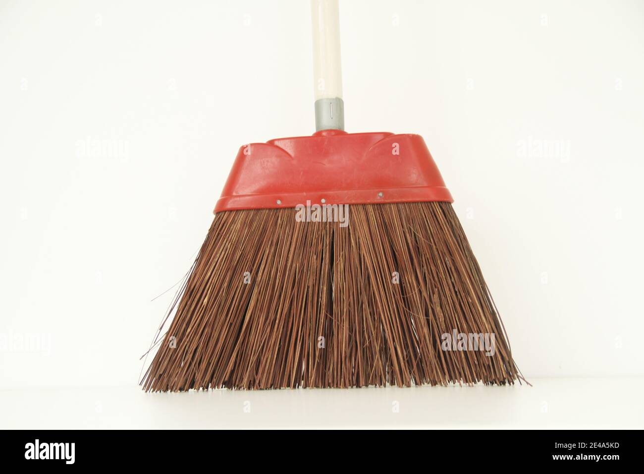 Piassava, piaçava broom with long wooden handle isolated on white ...