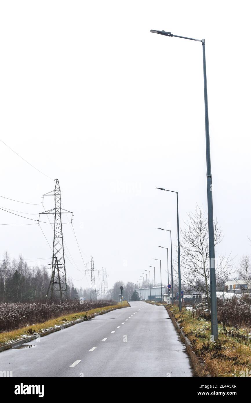 Street with led street lamps alongside and powerline on oposite side ...