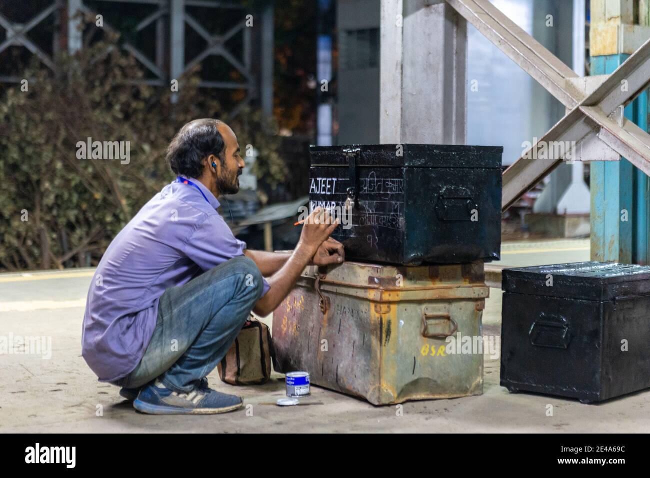 Railway station staff writing name of newly joined loco pilot on a line ...
