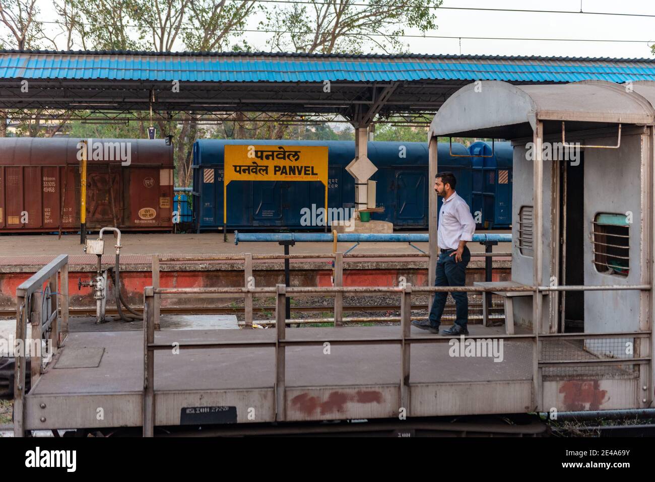 Guard of a freight train takes a stroll outside his cabin as his train ...