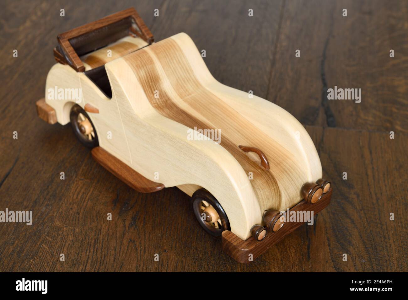 Two toned wooden hand crafted classic car on wood floor front view ...