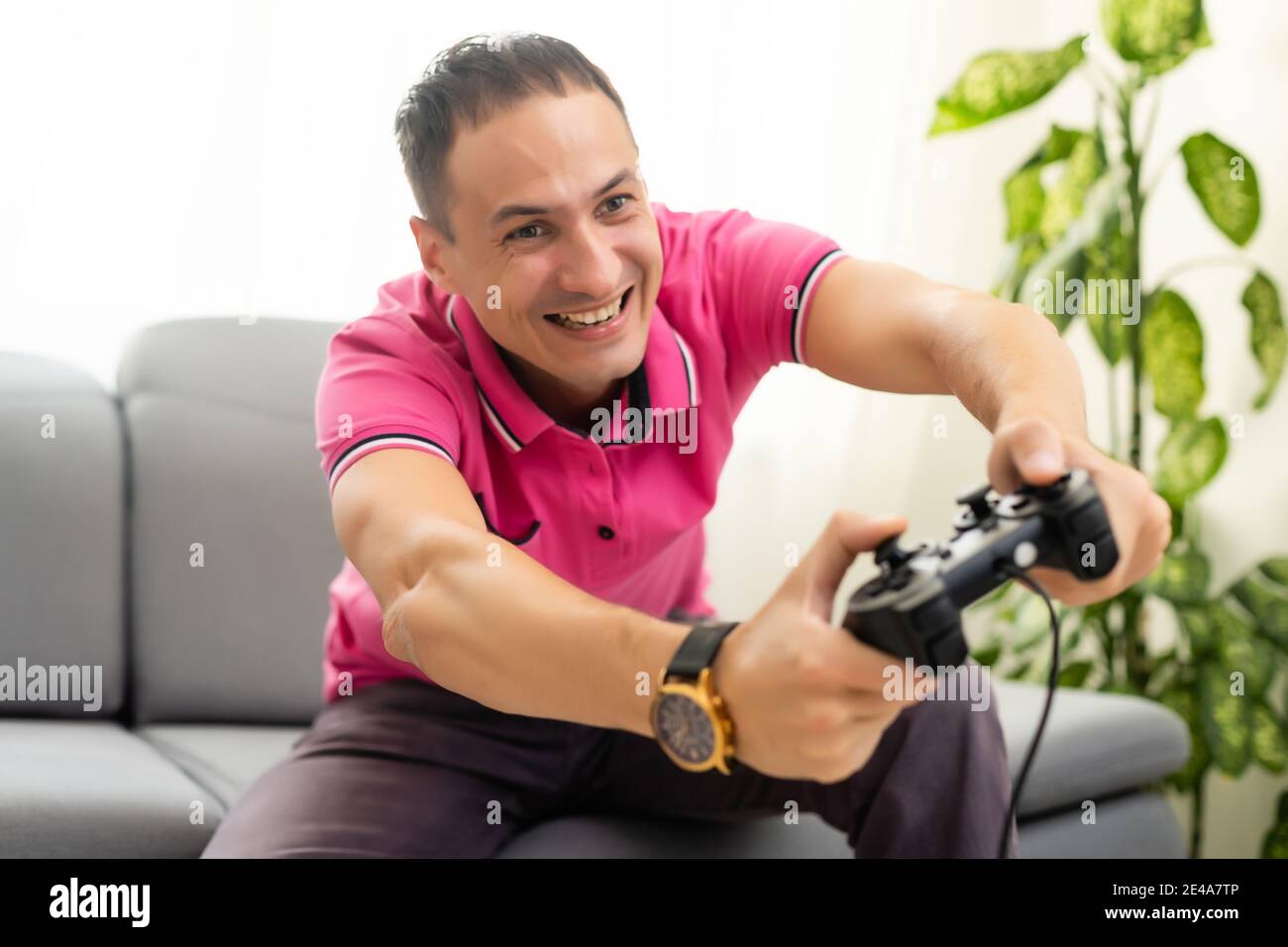 Man playing with a video game controller Stock Photo - Alamy