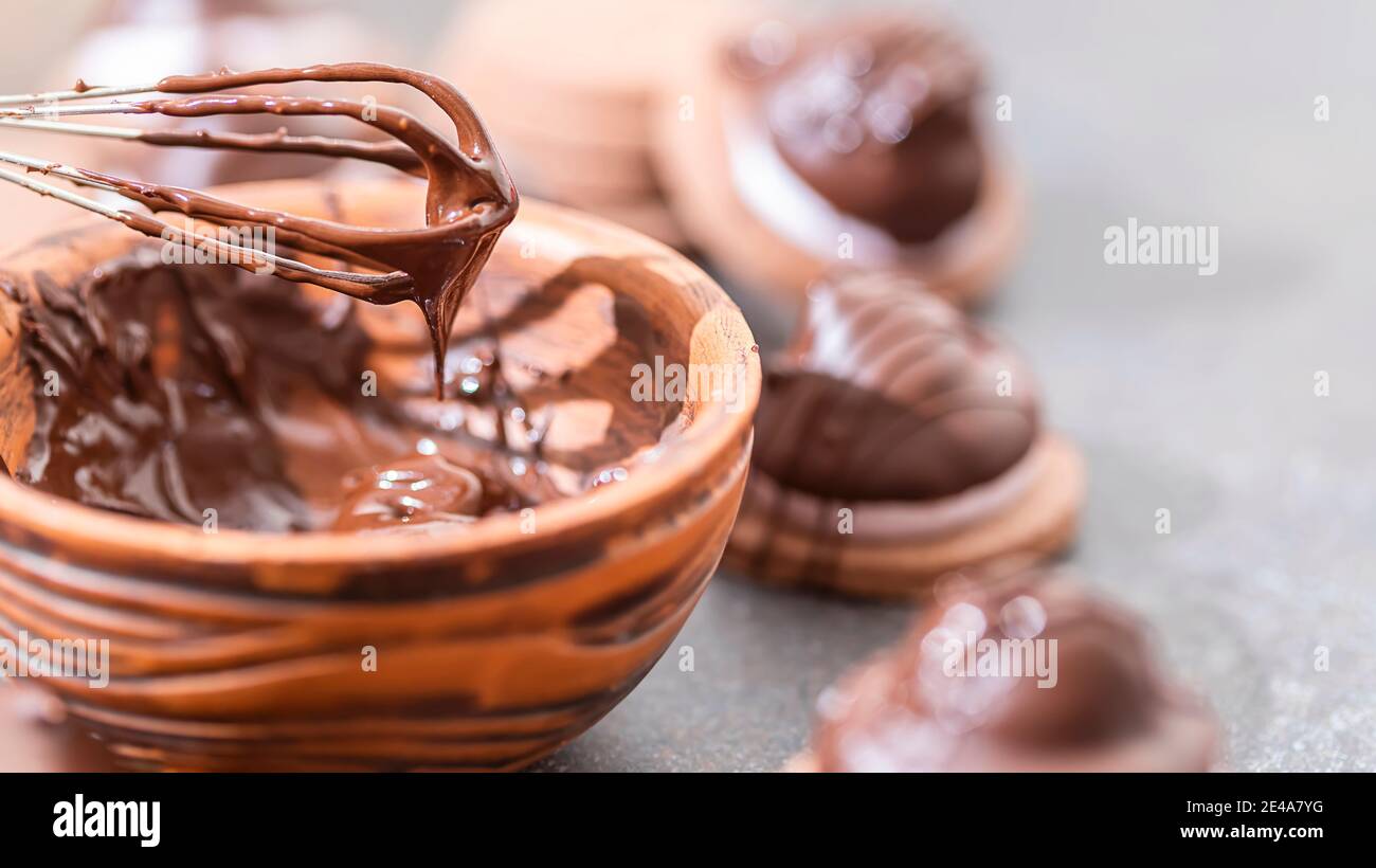 Homemade baking. Coating the pastry with melted chocolate. Selective ...