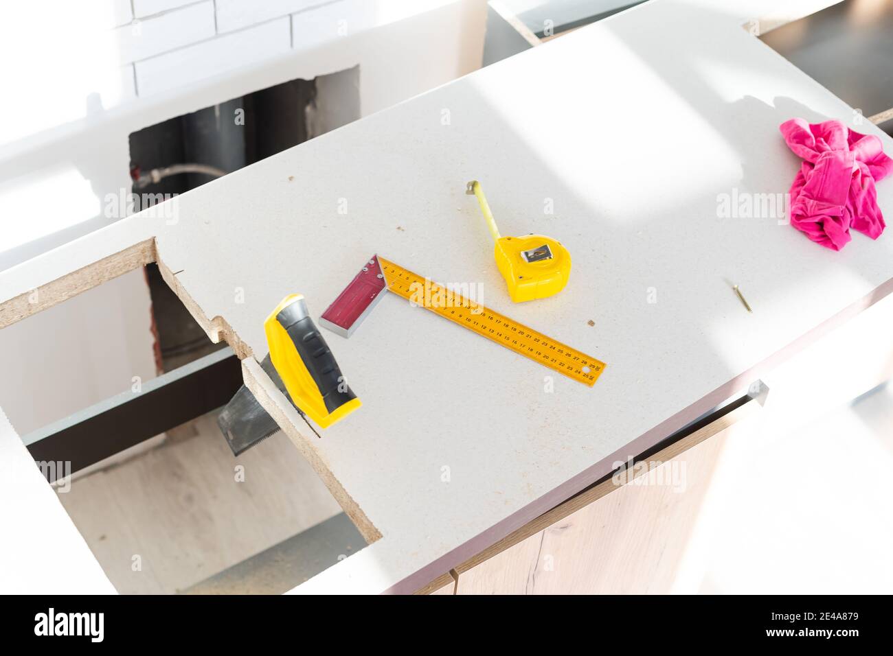 to cut holes in the kitchen countertop for equipment Stock Photo - Alamy
