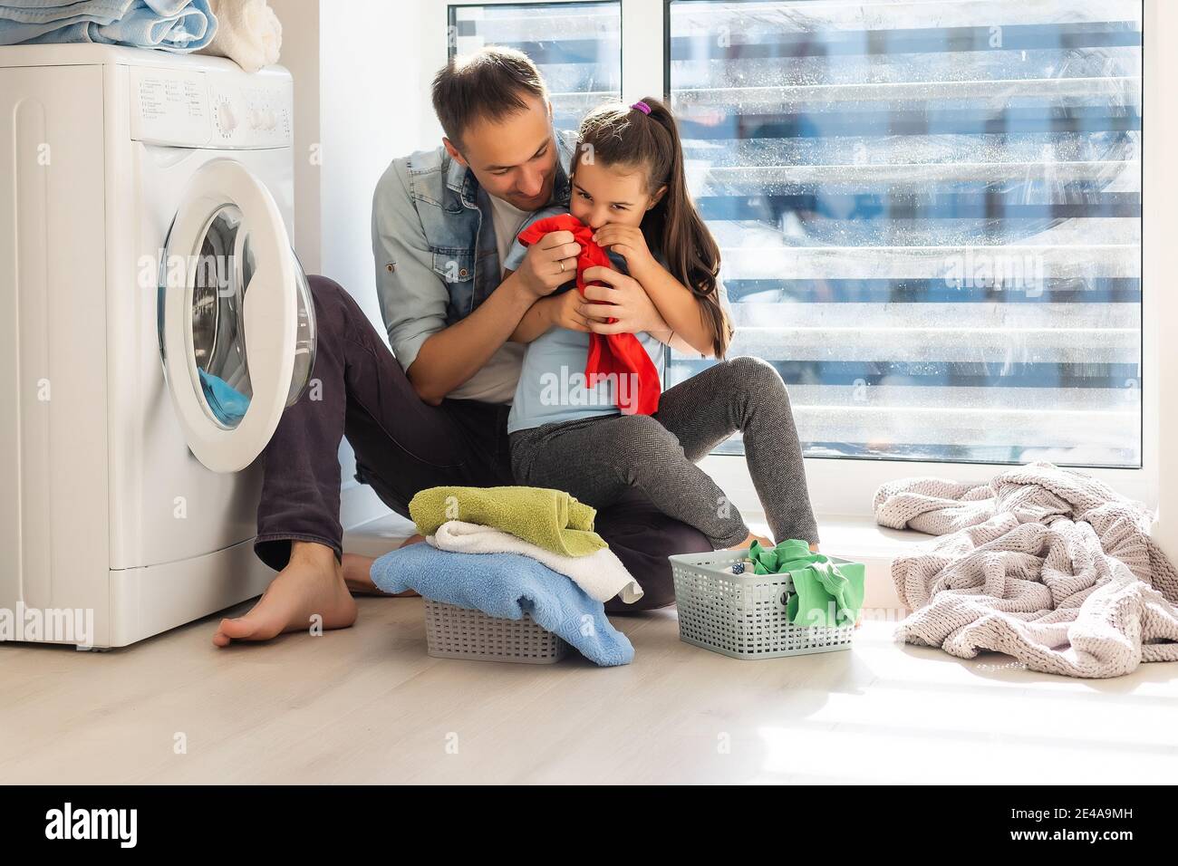 happy casual multiethnic family laundry clothes at home Stock Photo - Alamy