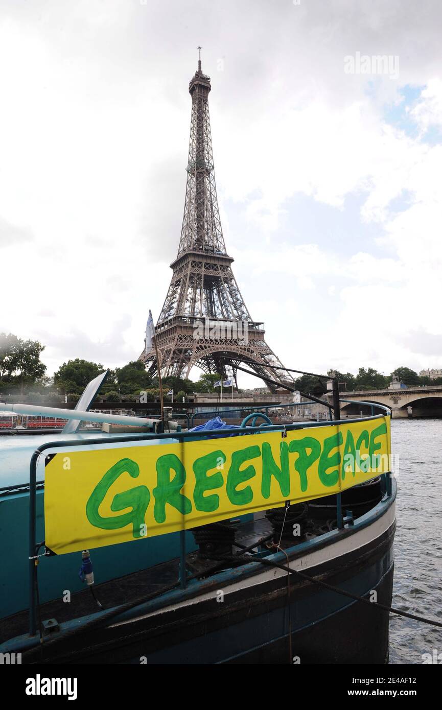A giant iceberg is displayed on the Seine river next to the Eiffel ...