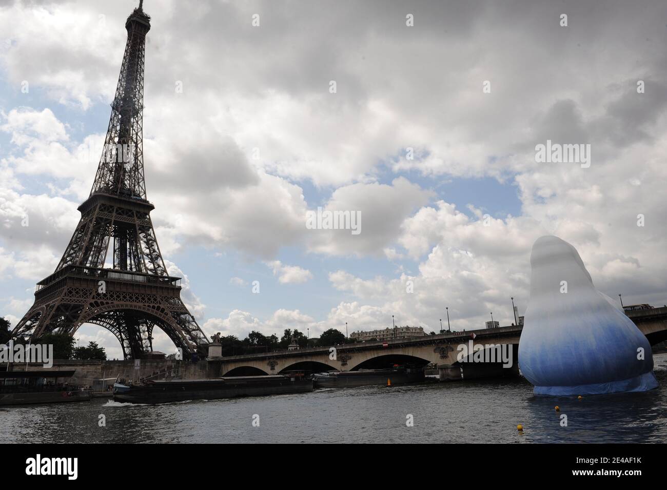 A giant iceberg is displayed on the Seine river next to the Eiffel ...