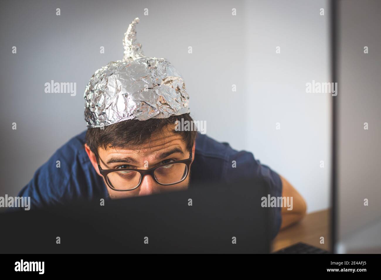 Young man is wearing aluminum cap, conspiracy theory concept Stock ...