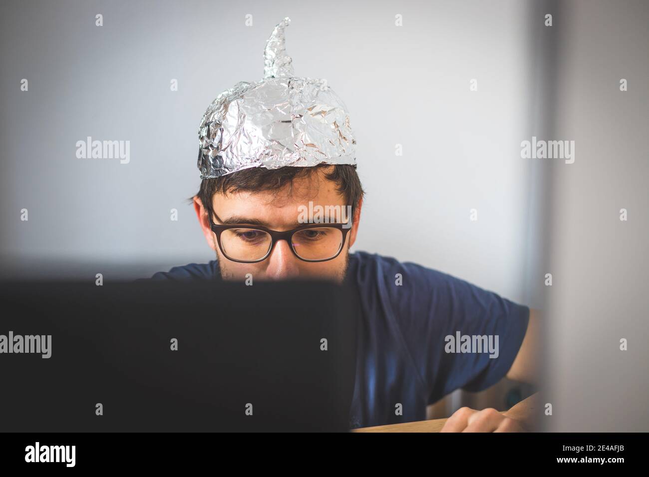 Young man is wearing aluminum cap, conspiracy theory concept Stock ...