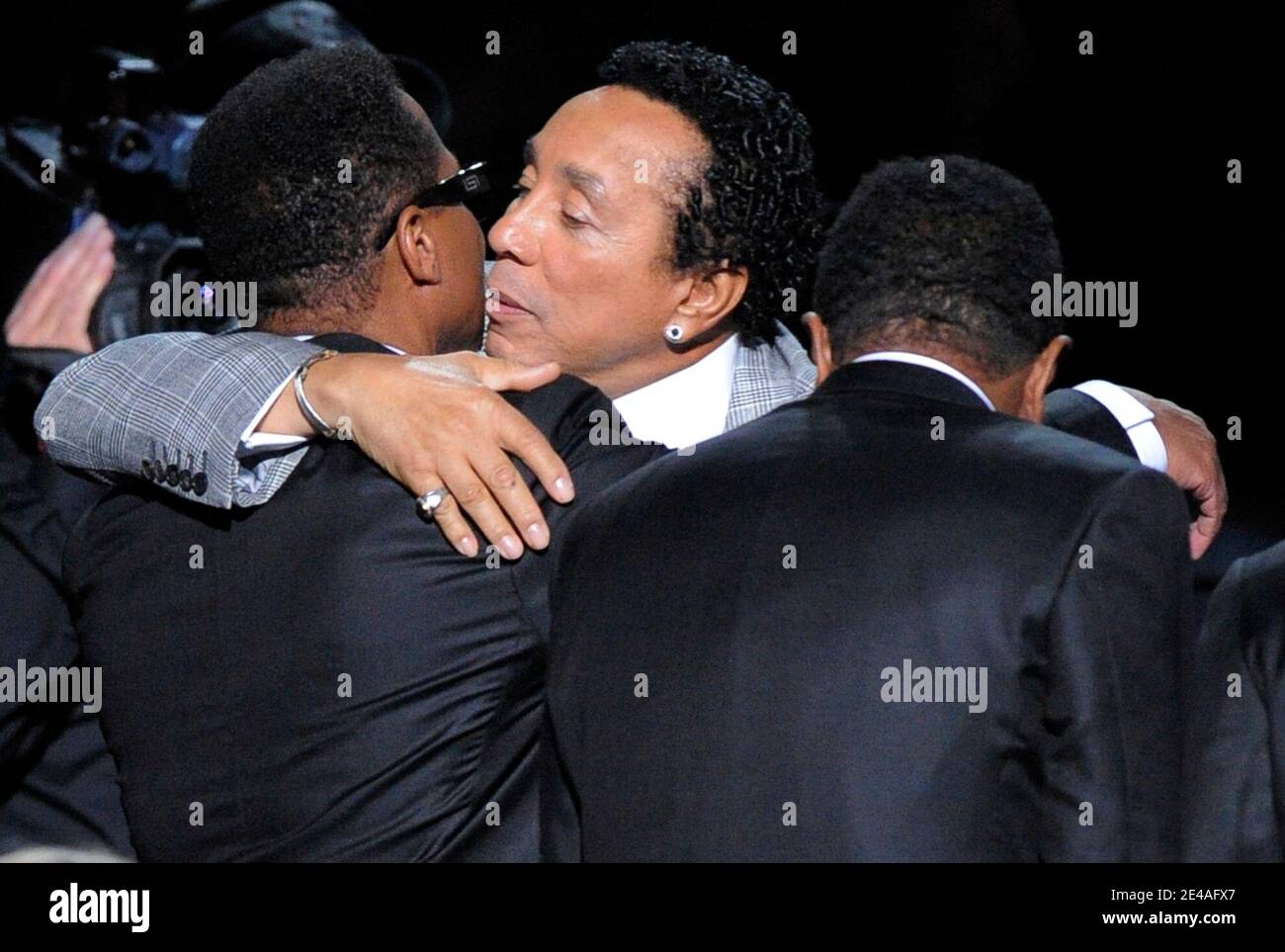 Singer Smokey Robinson hugs the Jackson brothers during the memorial ...