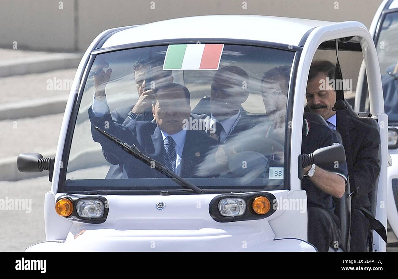 Italian Prime Minister Silvio Berlusconi arrives in a electric car for ...