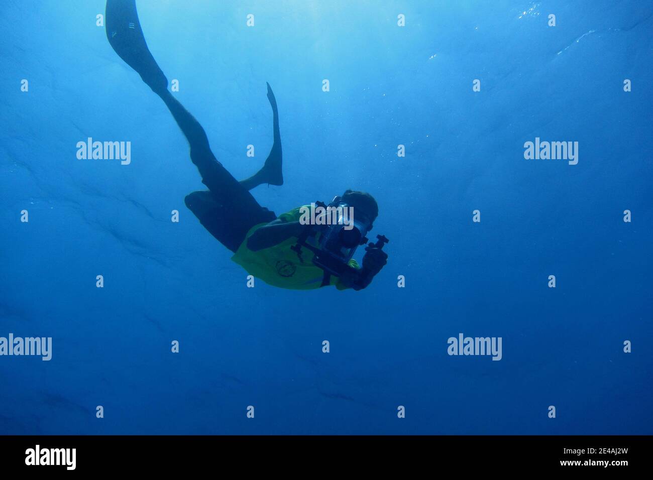 man with an underwater camera is filming in the blue sea Stock Photo ...