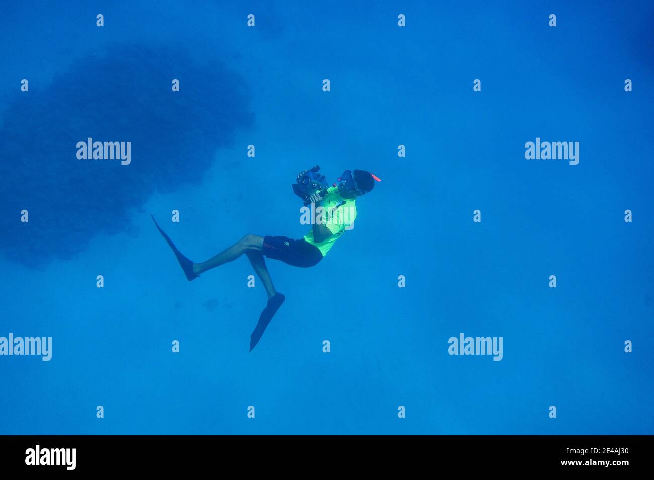 man with an underwater camera in the blue water Stock Photo - Alamy