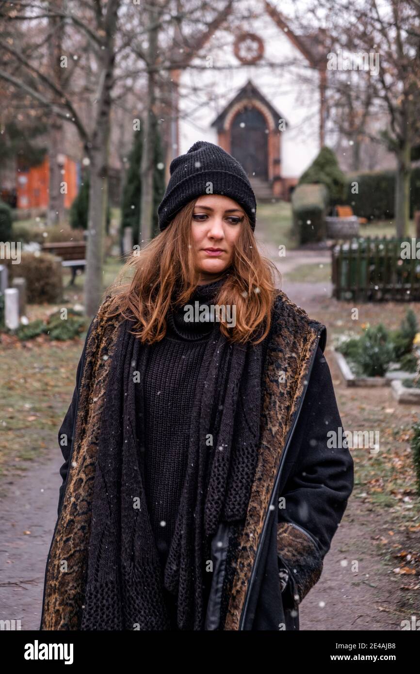 young sad brunette woman walking alone in cemetery Stock Photo - Alamy