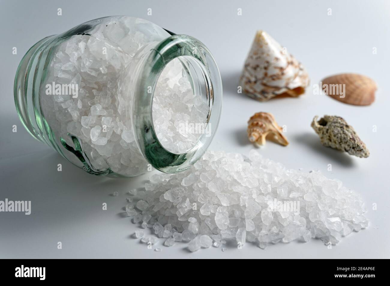 Sea salt in small glass jar on white background Stock Photo - Alamy