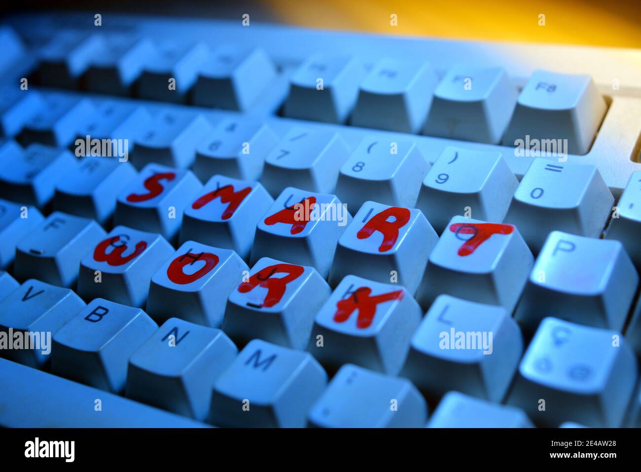 Detail of a computer keyboard with Smart Work written on it with marker ...