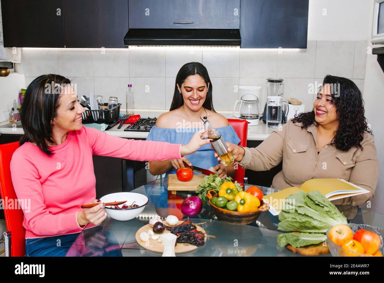 latin women cooking vegetables food and having fun in a mexican kitchen ...