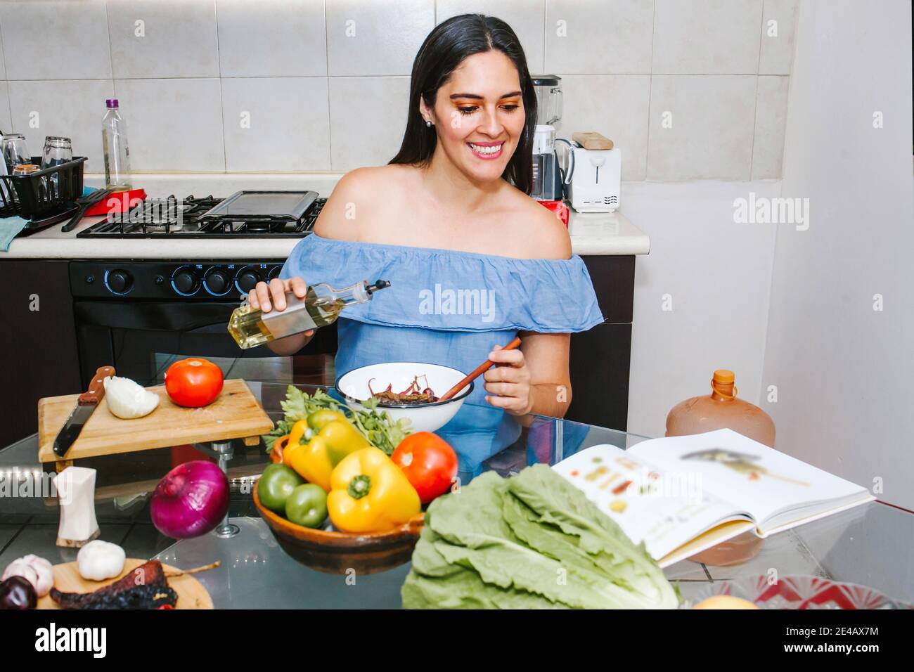 Latin woman cooking healthy food in a mexican kitchen in Mexico city ...