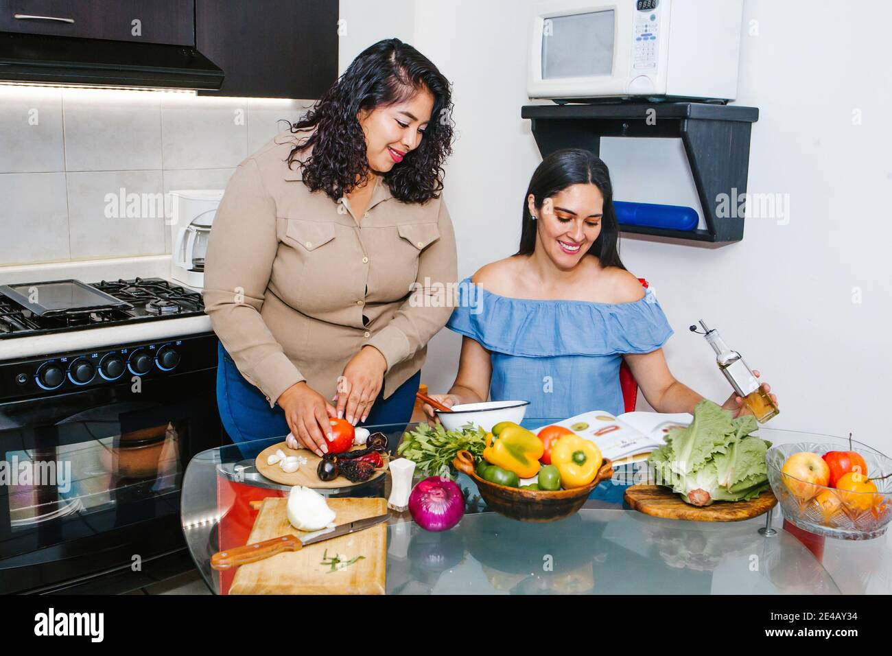 latin women cooking vegetables food and having fun in a mexican kitchen ...
