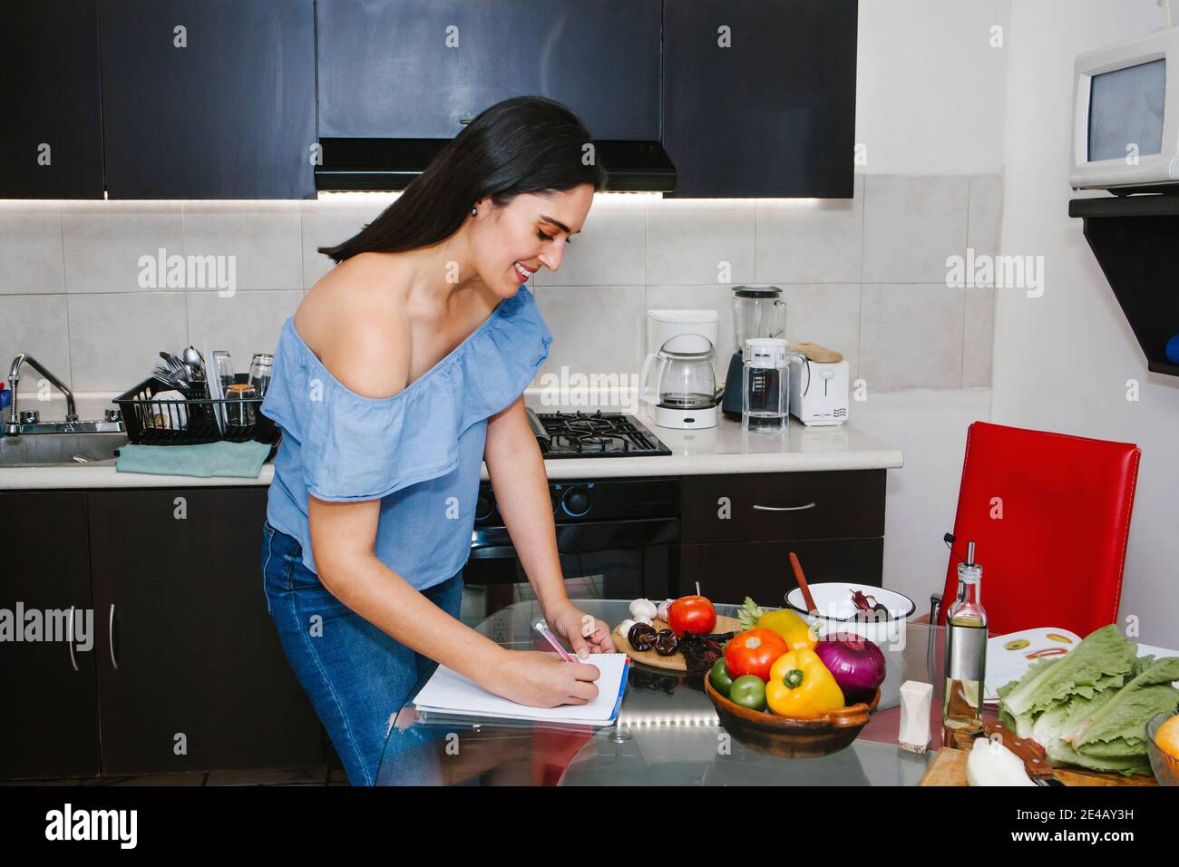 Latin woman cooking healthy food in a mexican kitchen in Mexico city ...