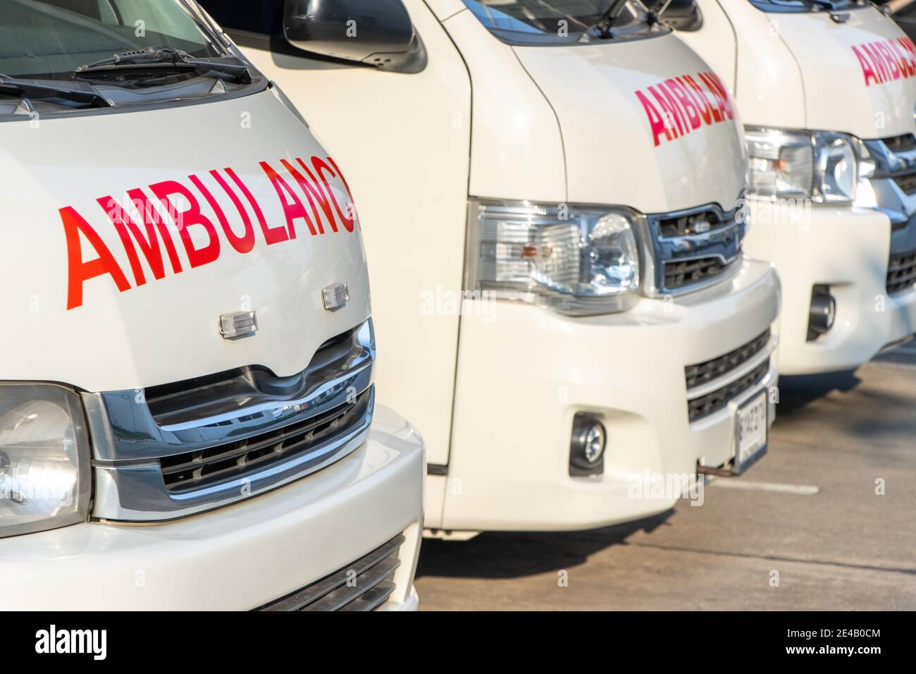 Front part of ambulances standing in parking lot of hospital. A row ...