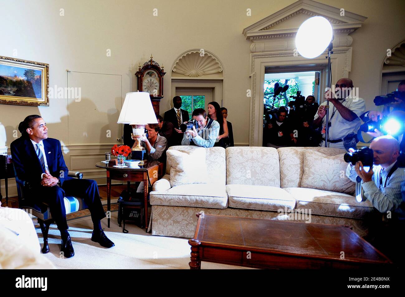 U.S. President Barack Obama sits in the Oval Office at the White House ...