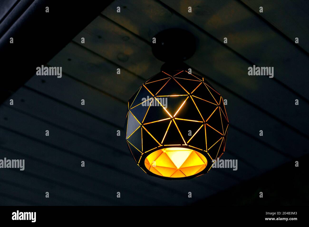 black hanging lantern on wooden ceiling by plank with triangle pattern ...