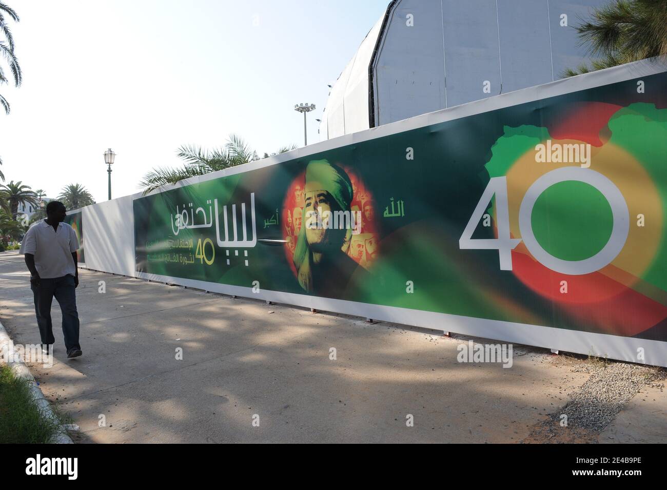 A poster celebrating Muammar Gaddafi's 40th anniversary of power is ...