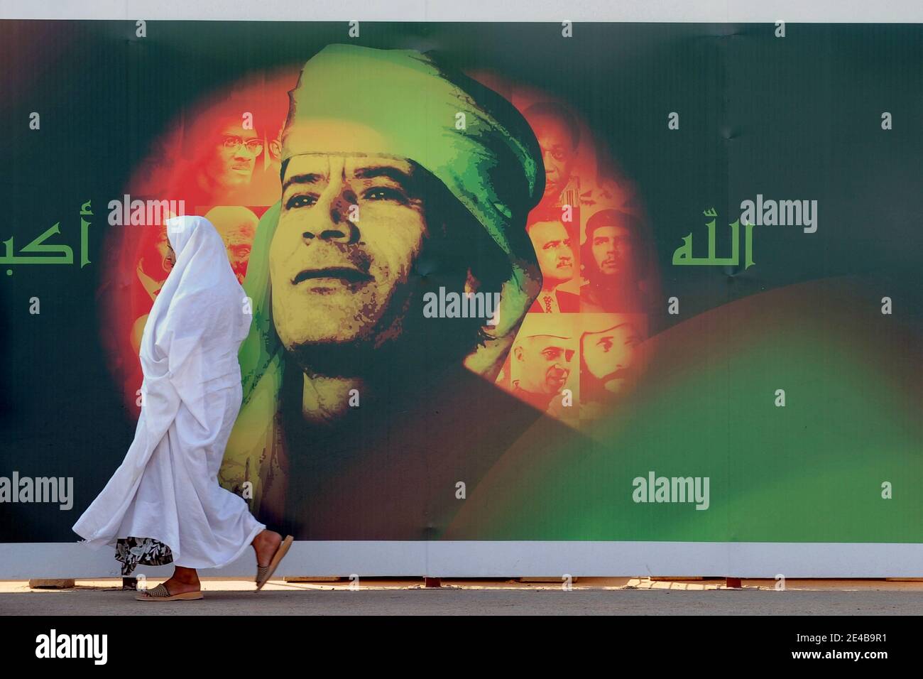 A poster celebrating Muammar Gaddafi's 40th anniversary of power is ...