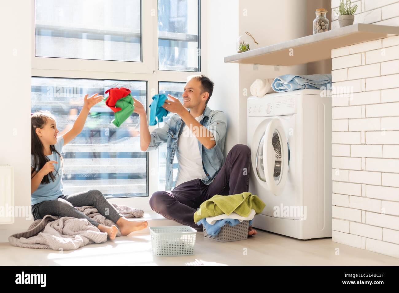 happy casual multiethnic family laundry clothes at home Stock Photo - Alamy