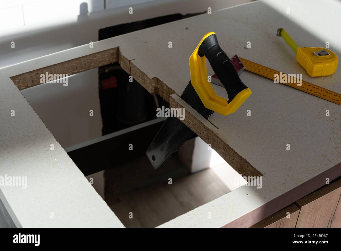 to cut holes in the kitchen countertop for equipment Stock Photo - Alamy