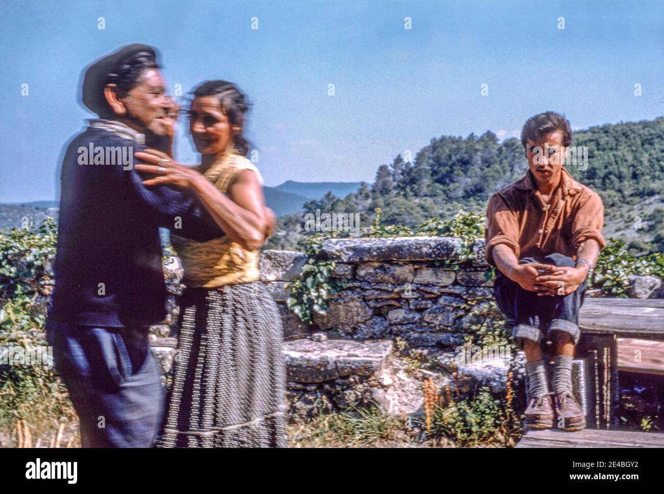 Older Gypsy couple dancing with young man watching, La Roque-sur-Cèze ...