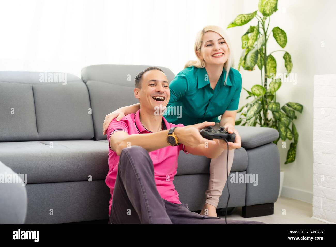 Couple playing video games at home Stock Photo - Alamy
