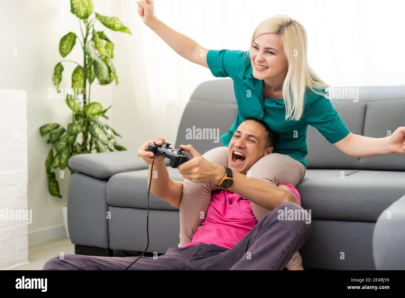 Portrait of happy excited family playing video games Stock Photo - Alamy